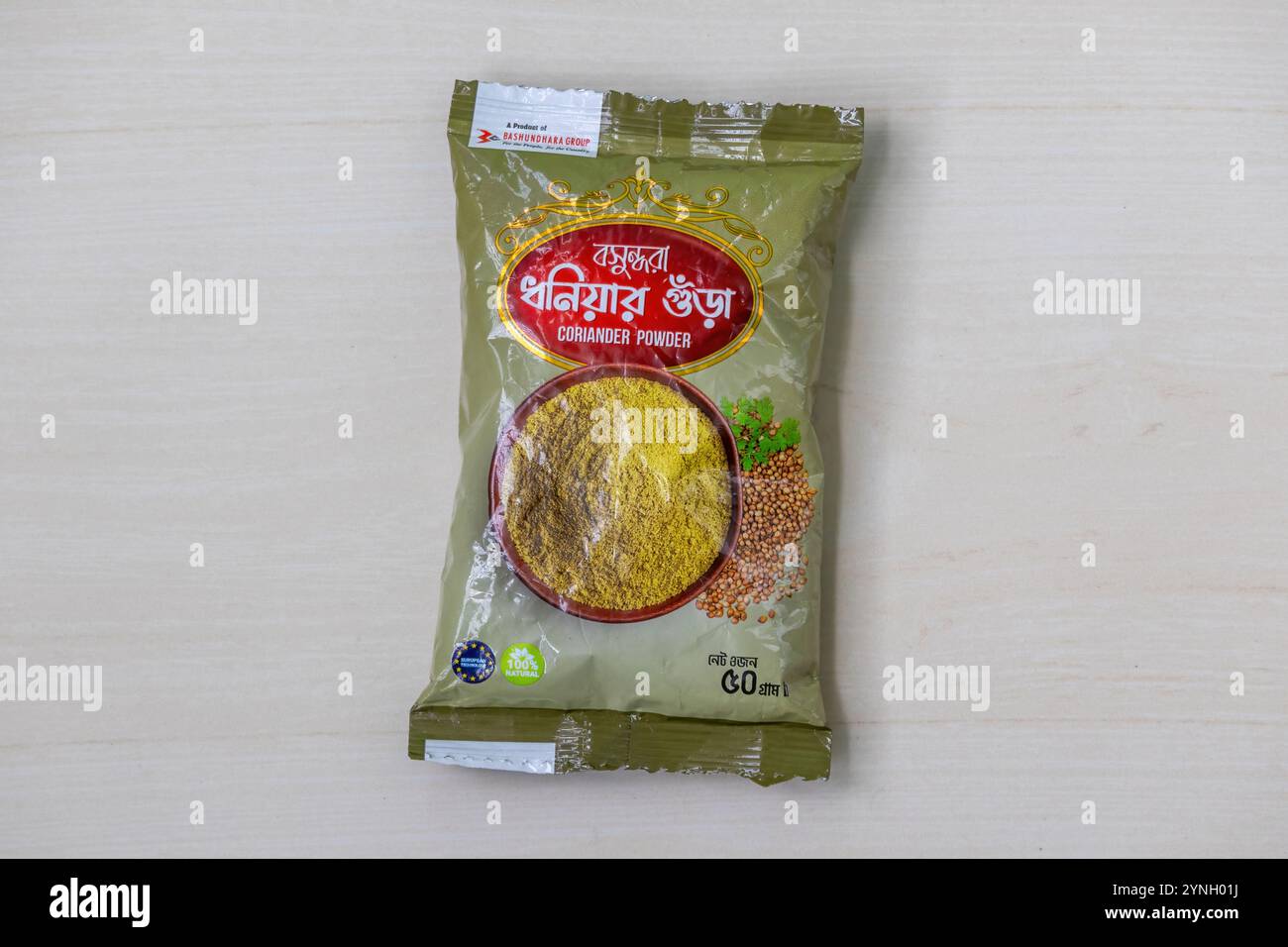 Packets of Bashundhara coriander powder (50g) displayed on a light ...