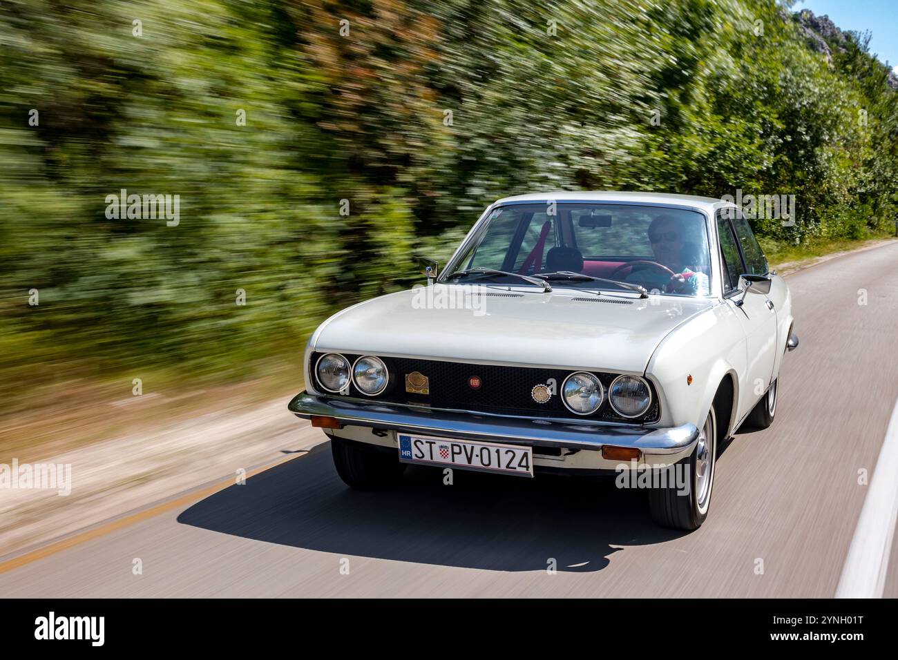 Classical Fiat 124 Sport Coupe on the road. Two-door, four-seater coupé ...