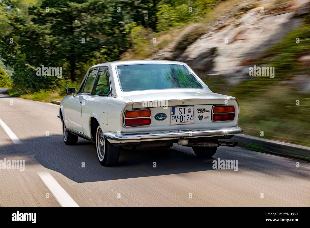 Classical Fiat 124 Sport Coupe on the road. Two-door, four-seater coupé ...
