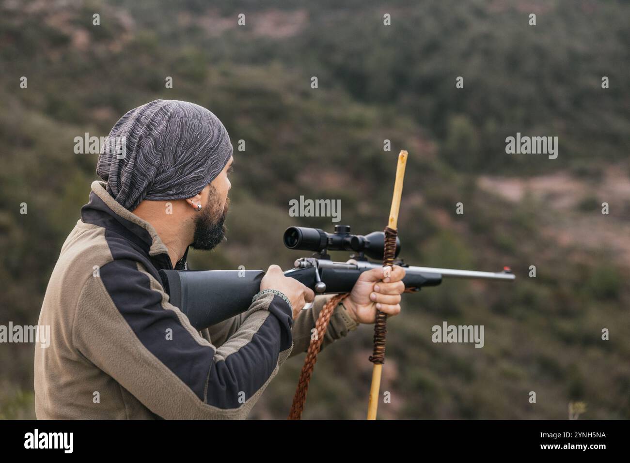 Hunter aiming with rifle in the mountain during hunting season Stock ...