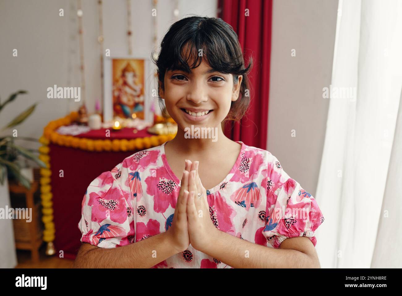 Smiling Girl with Hands in Namaste Gesture Stock Photo - Alamy
