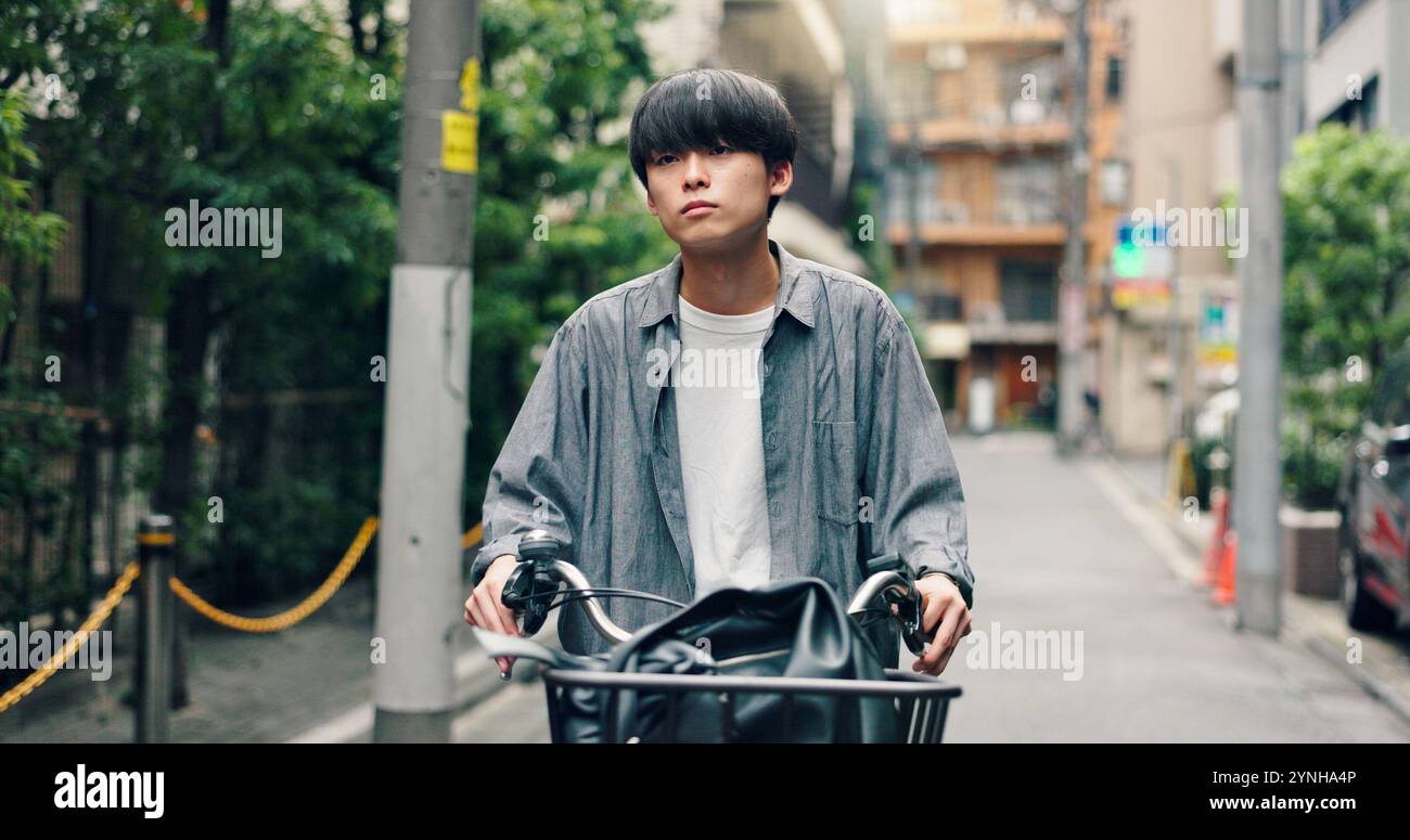 Travel, street and Asian man with bicycle in city for commute ...