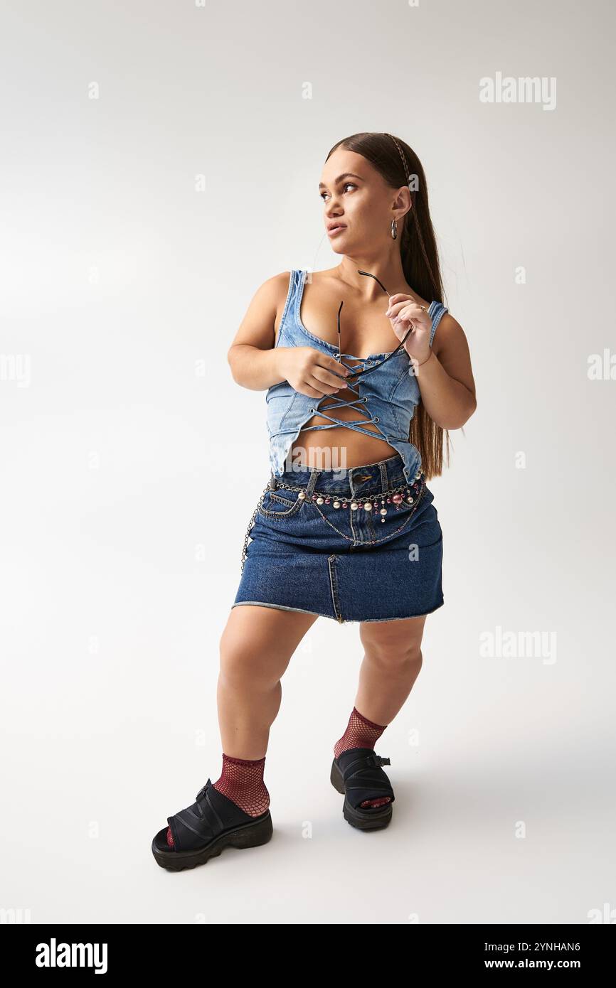 A Confident Young Woman With Achondroplasia In Trendy Denim Showcases