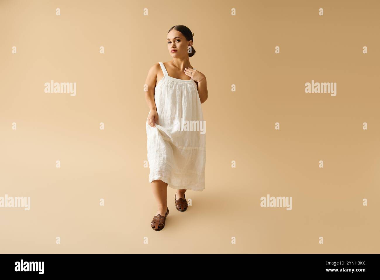 A young woman with short stature gracefully models a beautiful dress in ...
