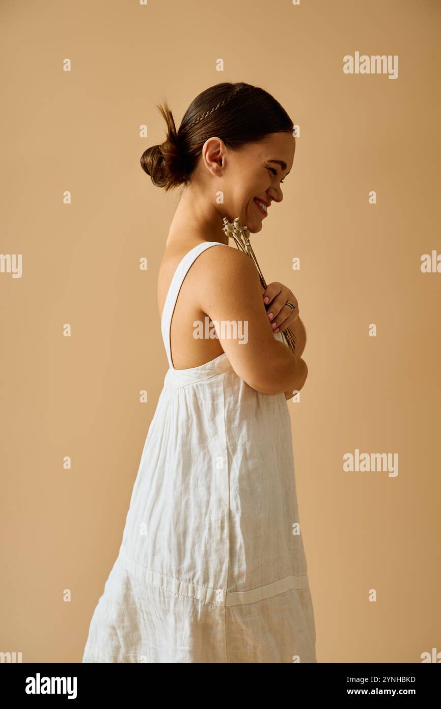 A young woman with short stature gently holds flowers while dressed ...