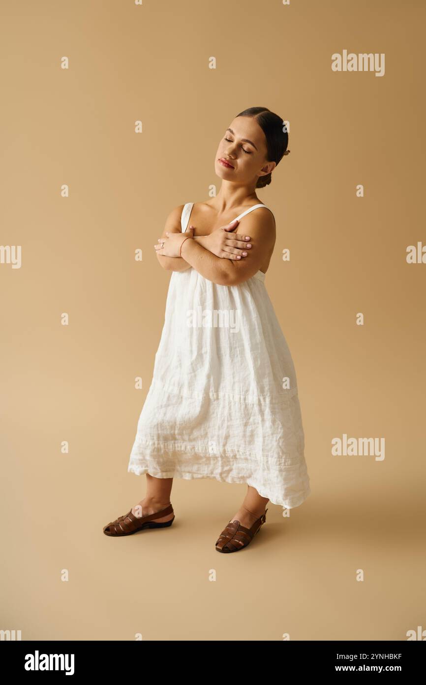 A young woman with short stature poses gracefully in a light dress ...