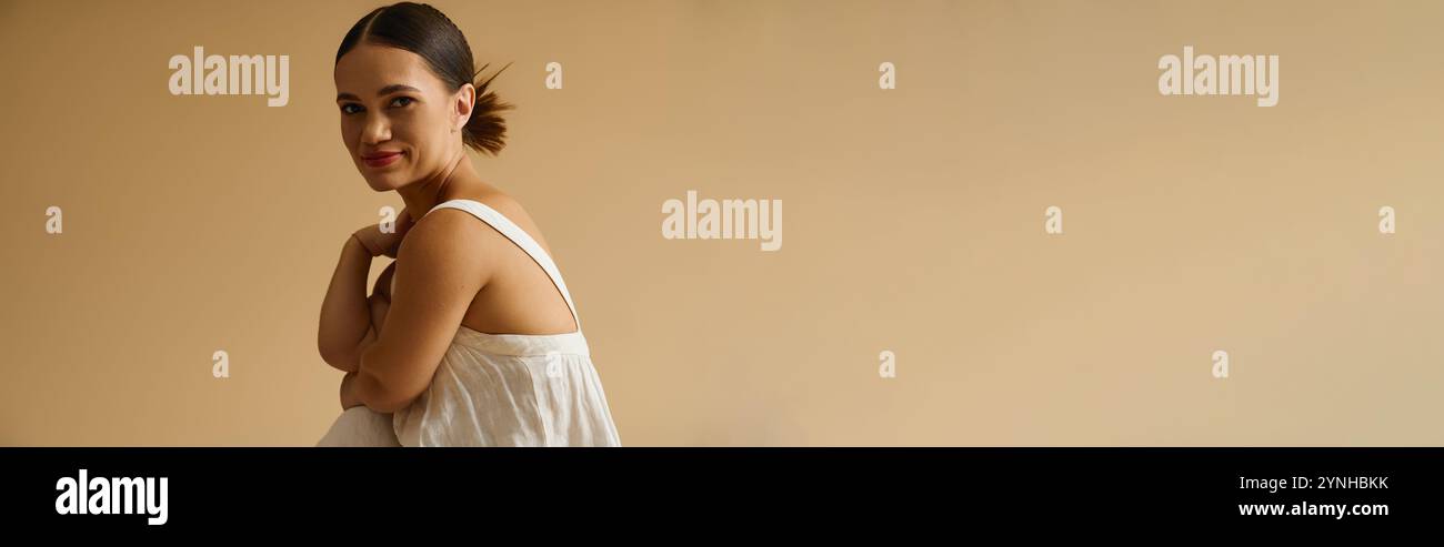 A young woman with short stature poses gracefully in a pretty dress ...