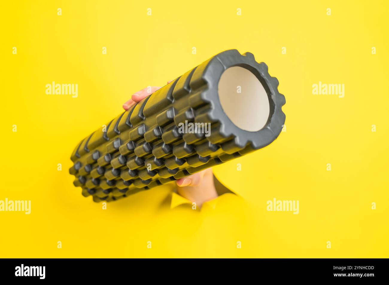 Female hand sticking out with MFR roller yellow paper background Stock ...