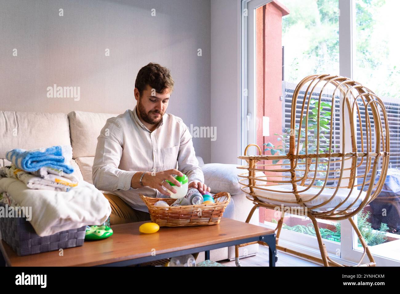 Father placing newborn baby's things at home Stock Photo - Alamy