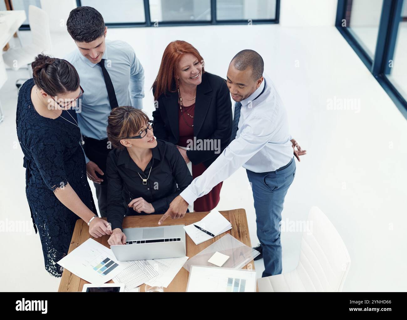 Business people, group and discussion by laptop, documents and point ...