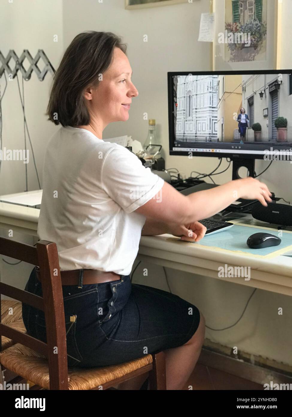 Professional photographer meticulously analyzes her latest work on a ...