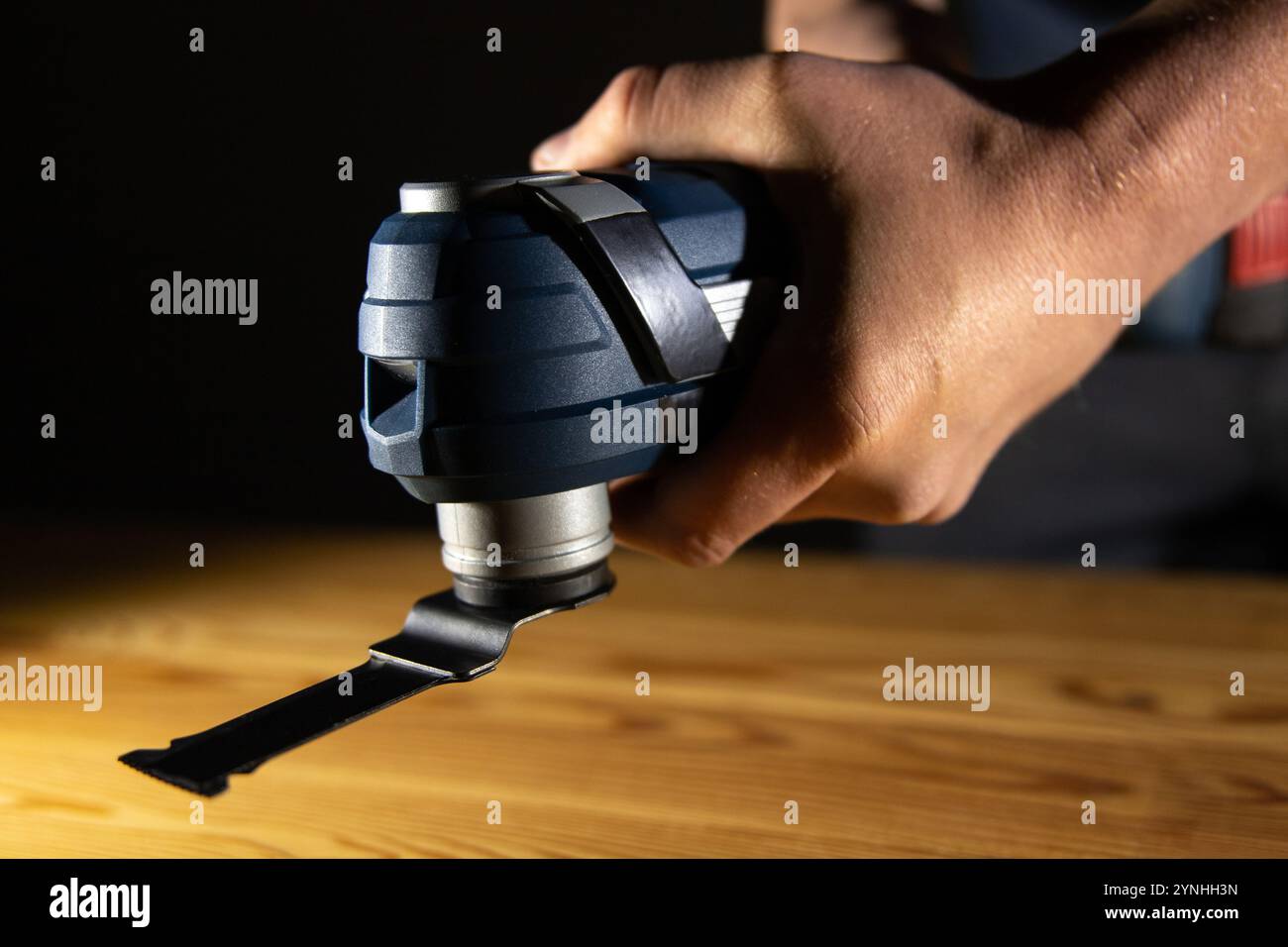 Hand Holding an Oscillating Tool Multi Cutter Designed for Precise ...