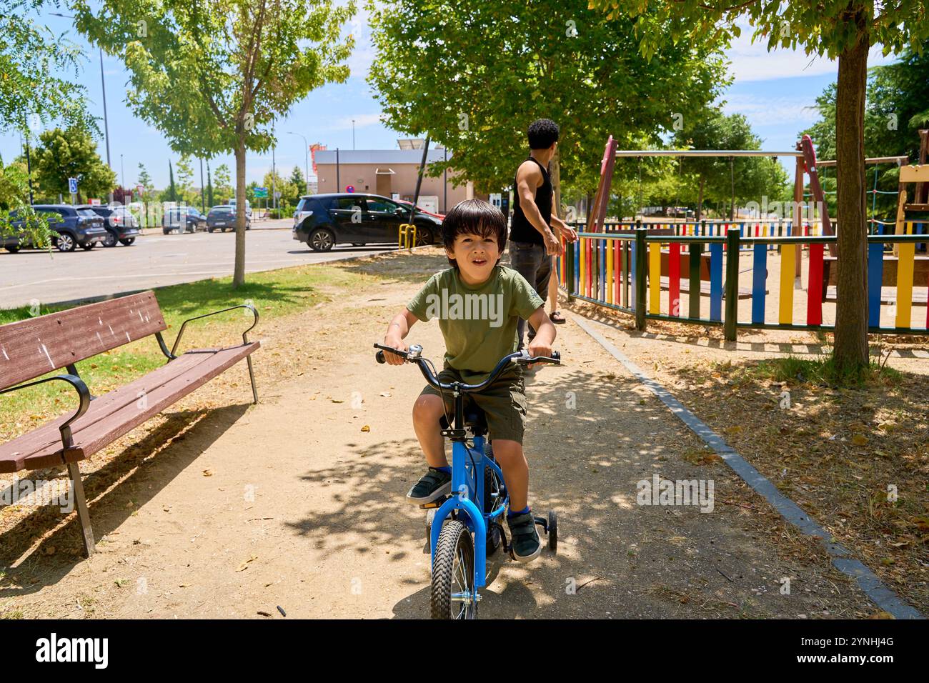 boy learning to ride a bike with his father Stock Photo - Alamy