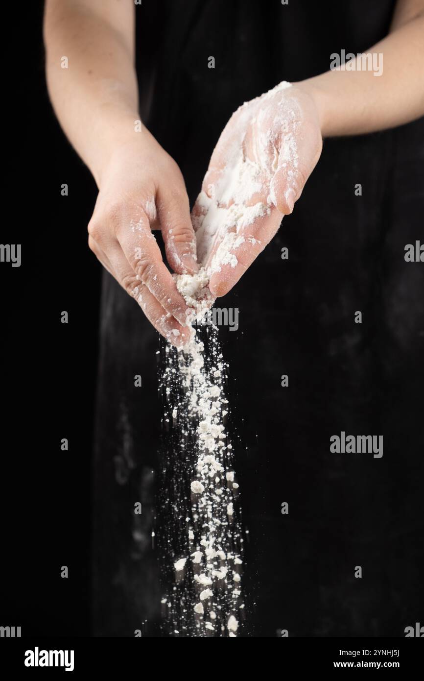 Cook pouring wheat white flour, hands close-up Stock Photo - Alamy