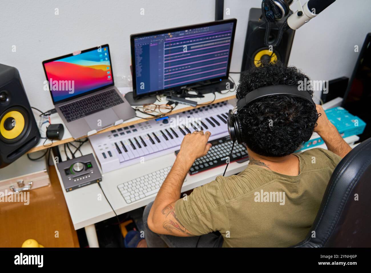set of a latin composer composing a song at home with a piano and two ...