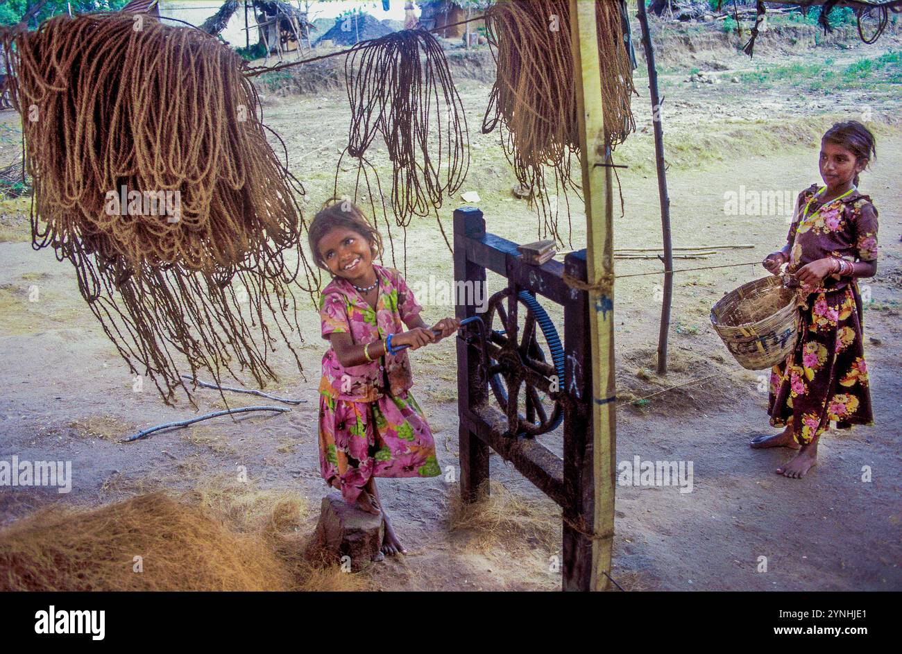 India, Tamil Nadu. Children work as rope makers. By turning a wheel ...