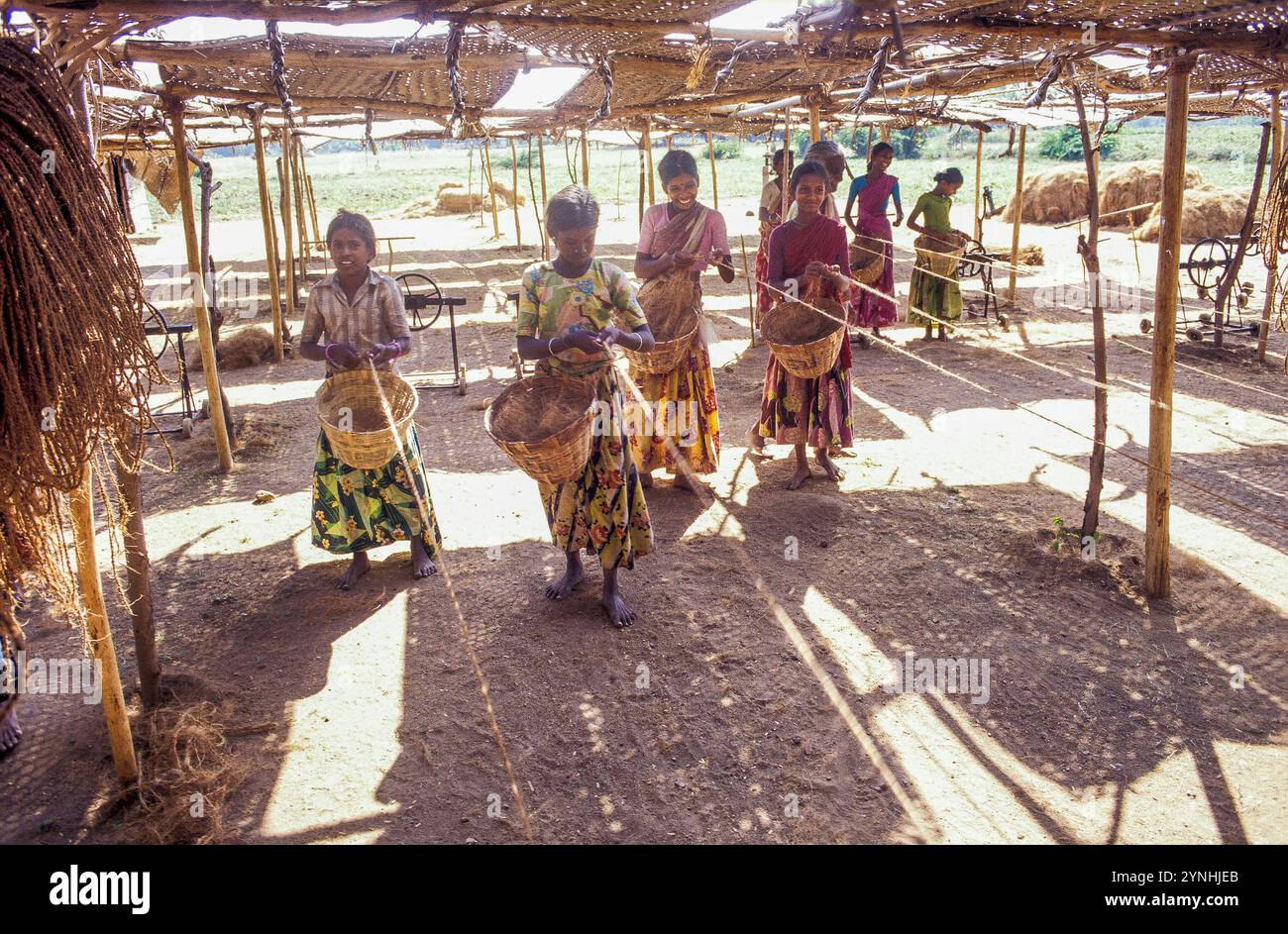 India, Tamil Nadu. Children work as rope makers. By turning a wheel ...