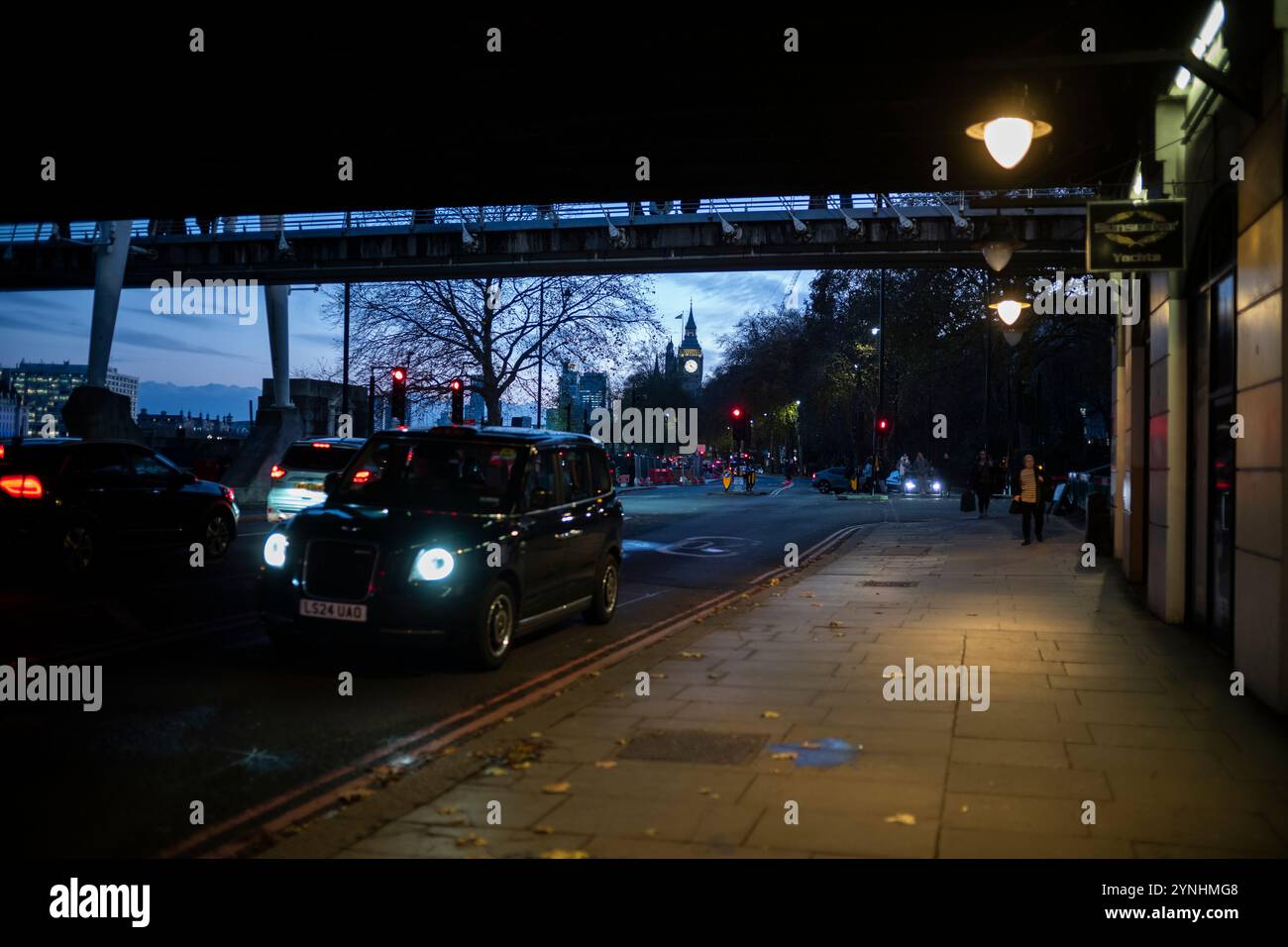 London taxi makes it's way under Waterloo Bridge, at Embankment with ...