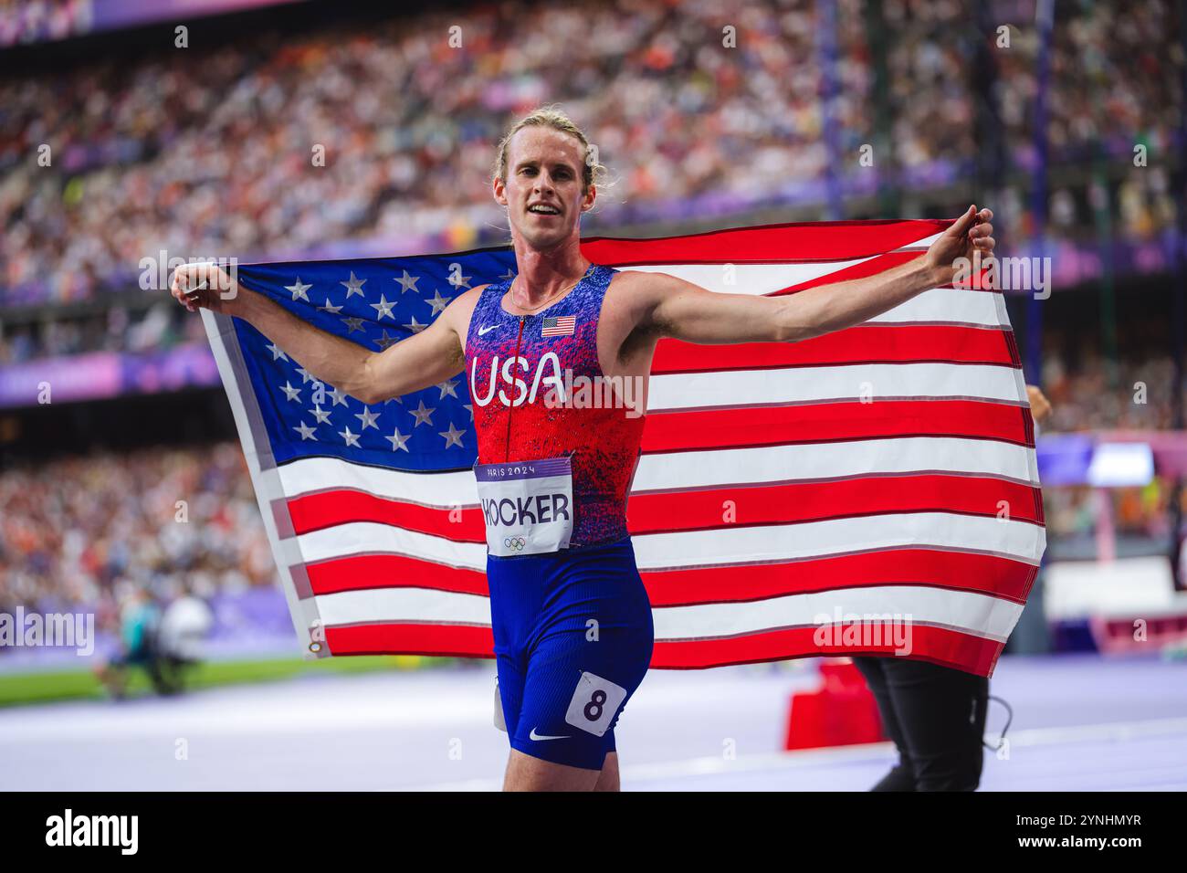 Cole Hocker celebrating her medal with her country's flag at the Paris ...