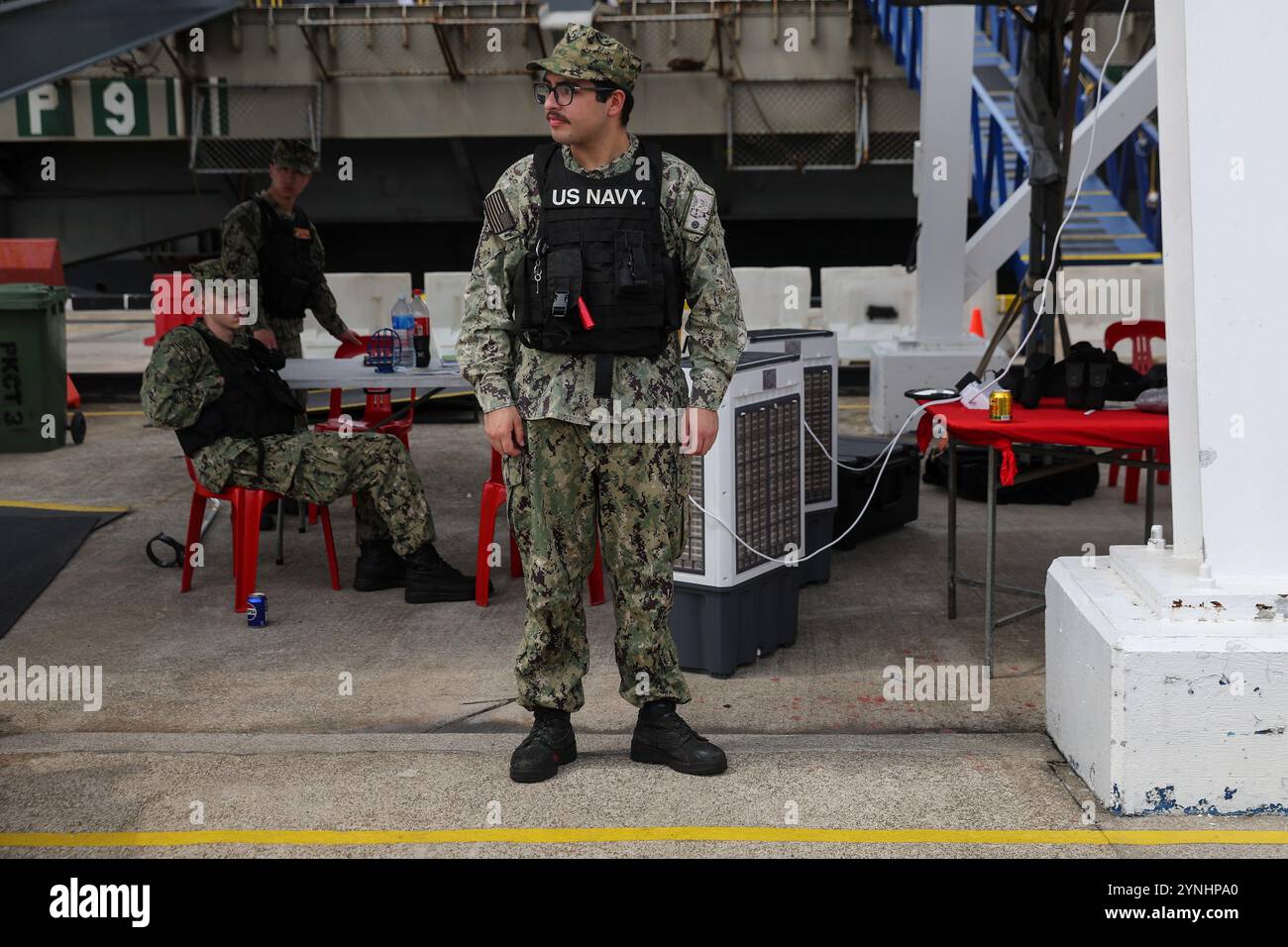 A U.S. Navy officer guards the entrance area of the USS Abraham Lincoln ...