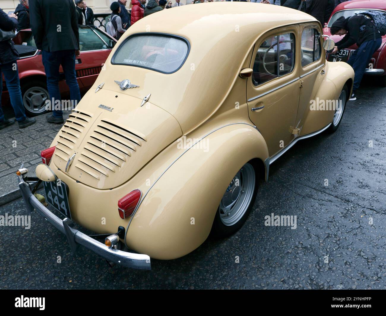 Three-quarter rear view of a Beige, 1955, Renault 4CV on display in ...