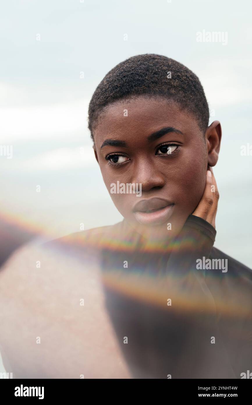 ethnic female with short hair touching face Stock Photo - Alamy