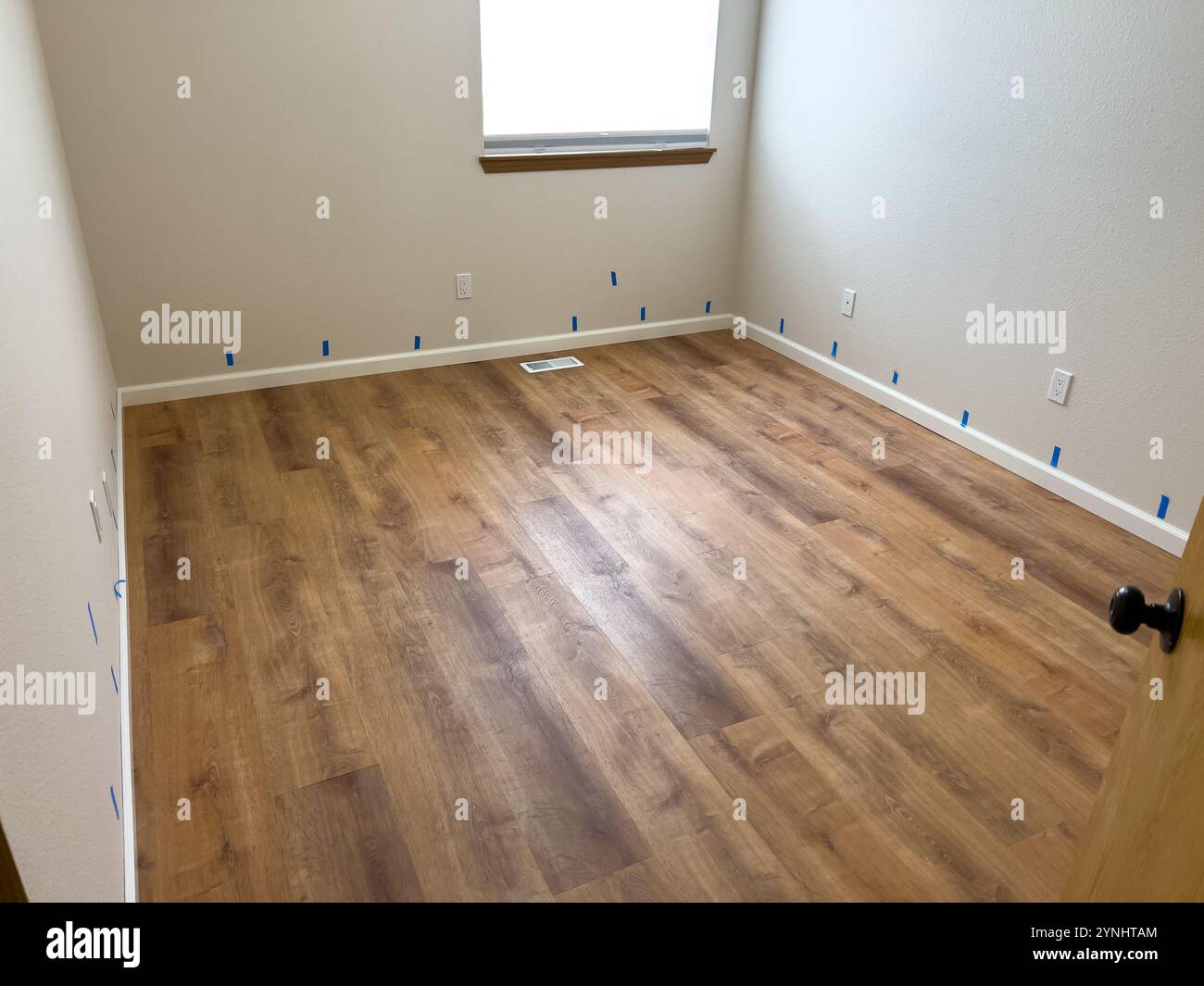 Vinyl Plank Flooring Installation with Baseboards Stock Photo - Alamy
