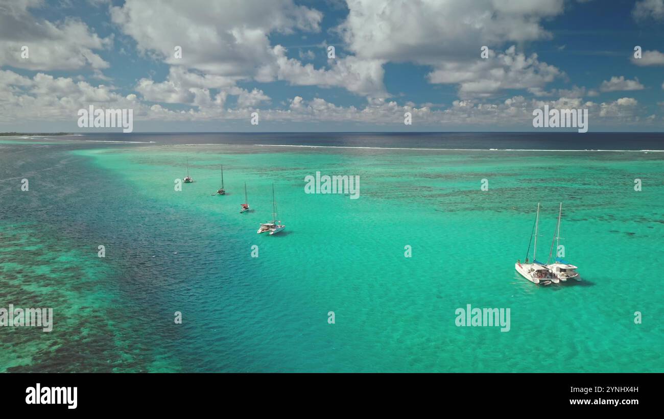 Group of catamarans peacefully float crystal clear turquoise waters ...