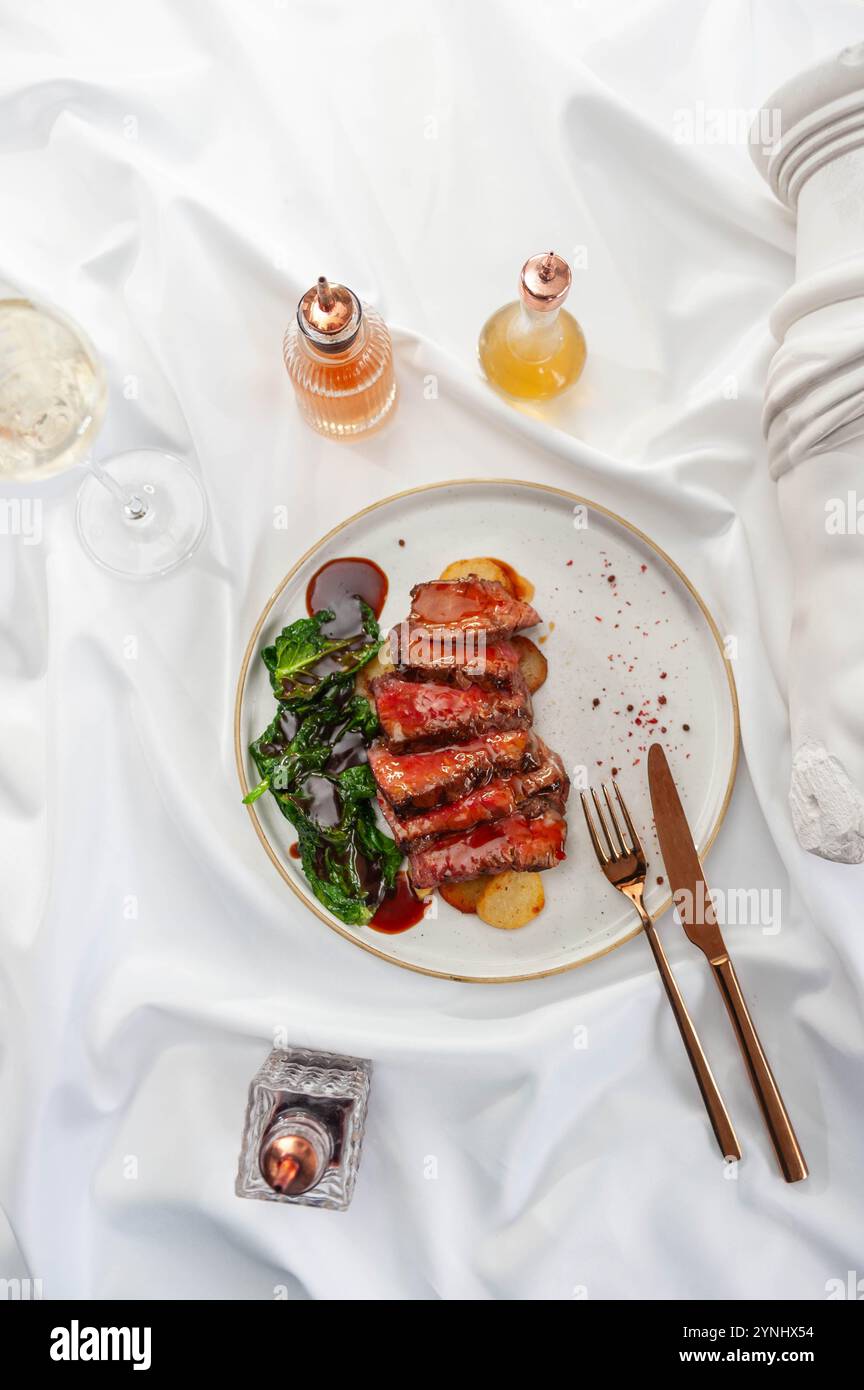 Beef Steak with Confit Potatoes and Spinach Stock Photo - Alamy