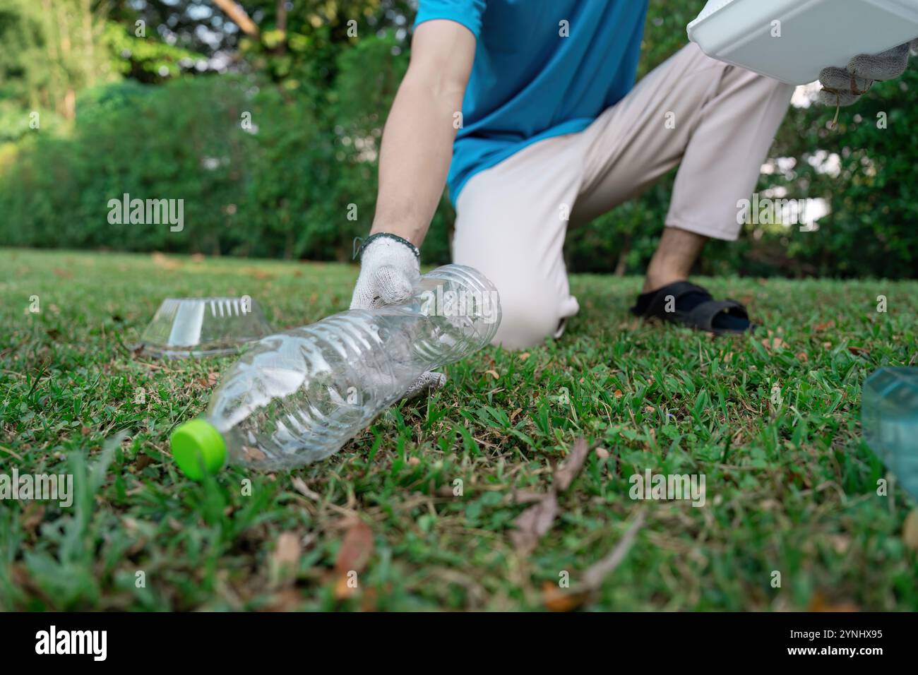 Community Volunteer Collecting Litter in Park to Promote Environmental ...