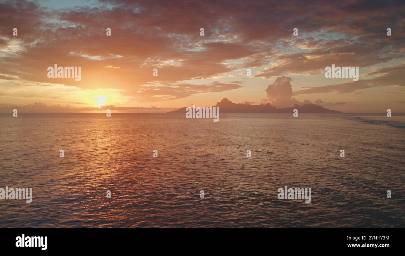 Aerial view of Moorea island during breathtaking golden sunset, with ...