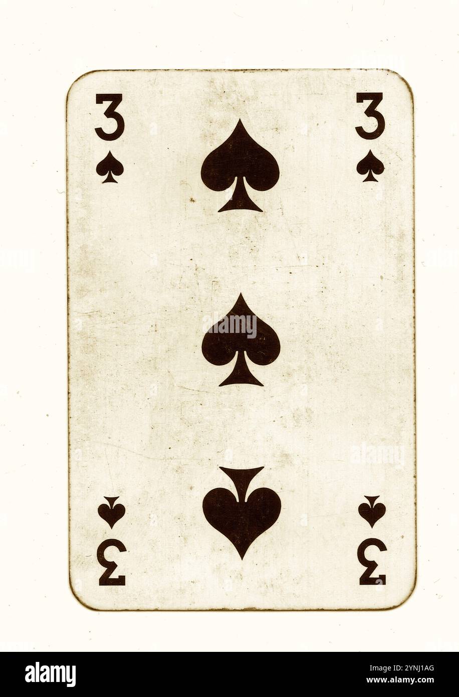 A vintage three of spades playing card in sepia isolated on a white ...