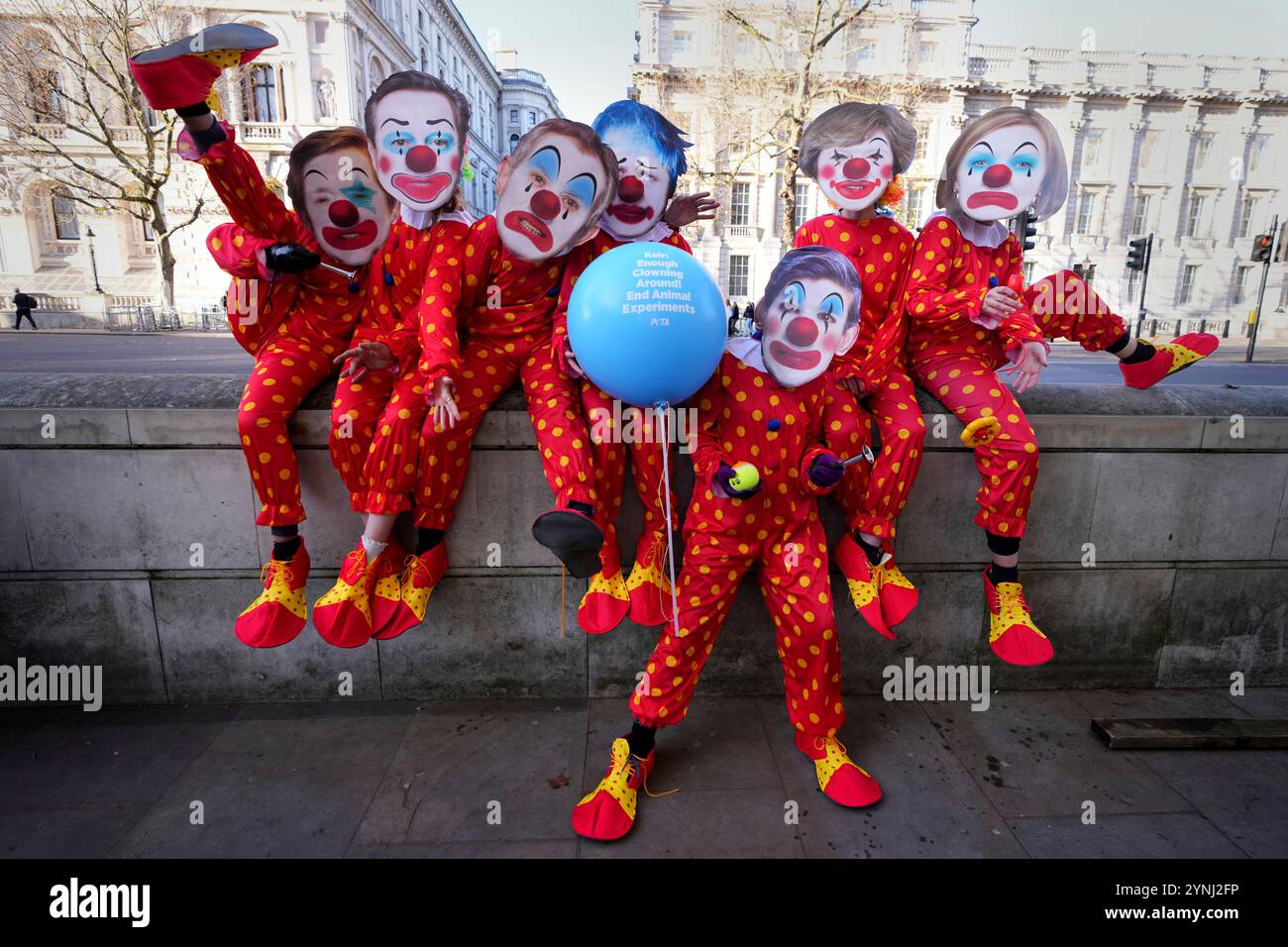 PETA supporters dressed as "clowns" and wearing masks depicting former ...