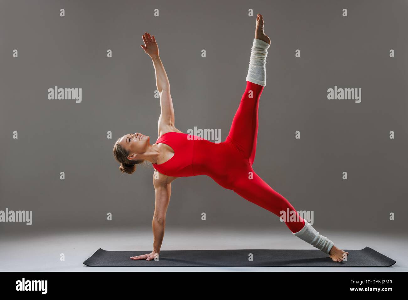 Pilates workout. Sporty girl, stretching legs, thigh muscles, squats ...