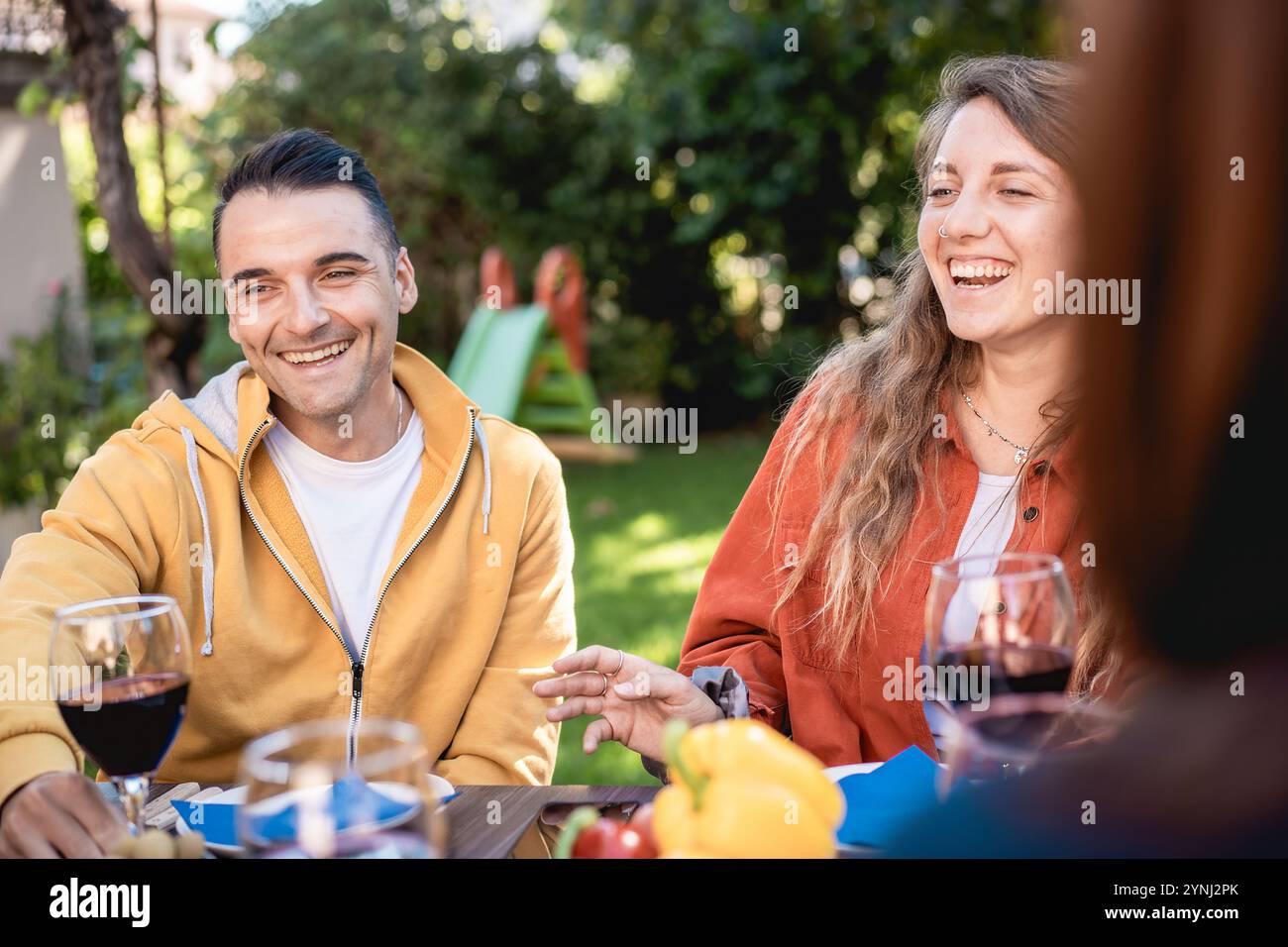 Contemporary moment of friends enjoying social gathering at outdoor ...