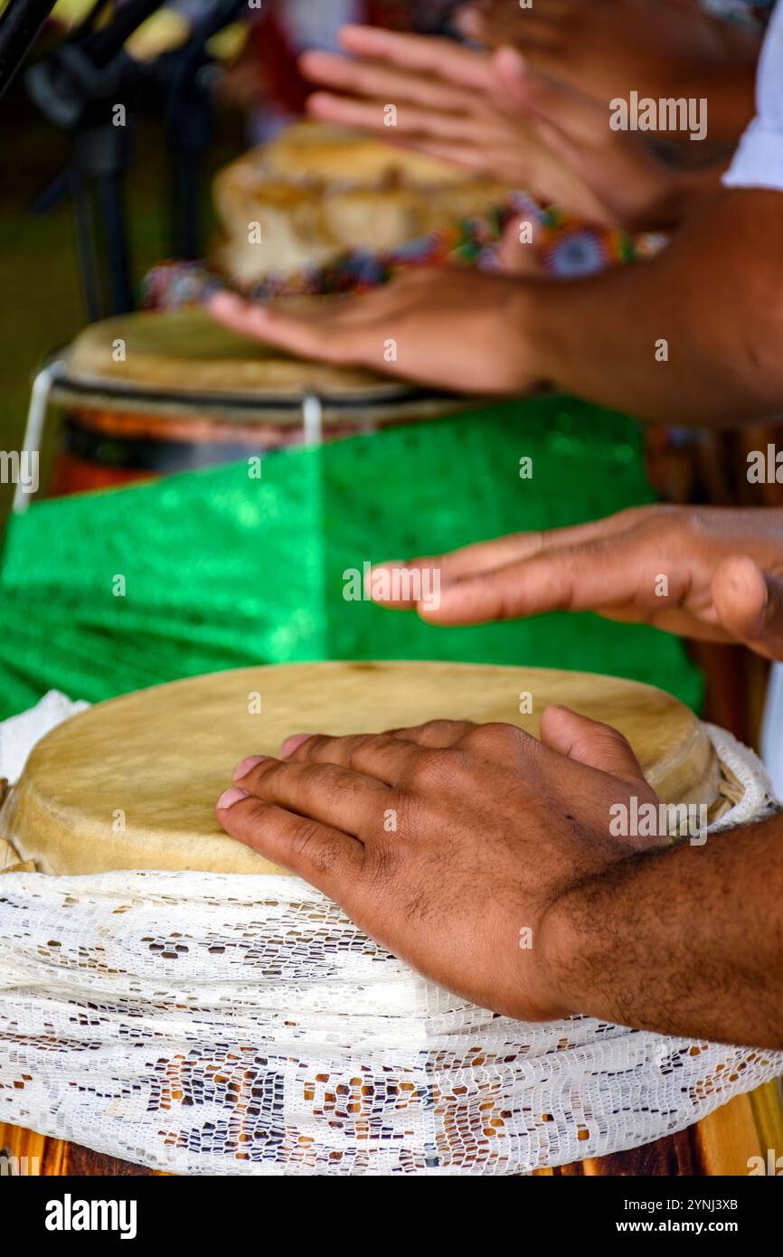Several atabaque drums decorated with fabric being used during an ...