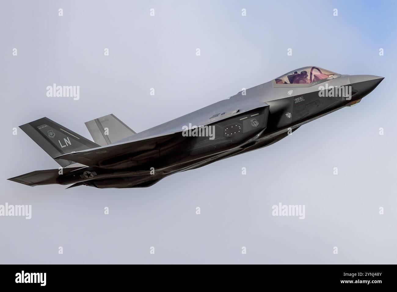 An F-35 Lightning II stealth fighter jet captured in mid-flight, showcasing its sleek design and ...