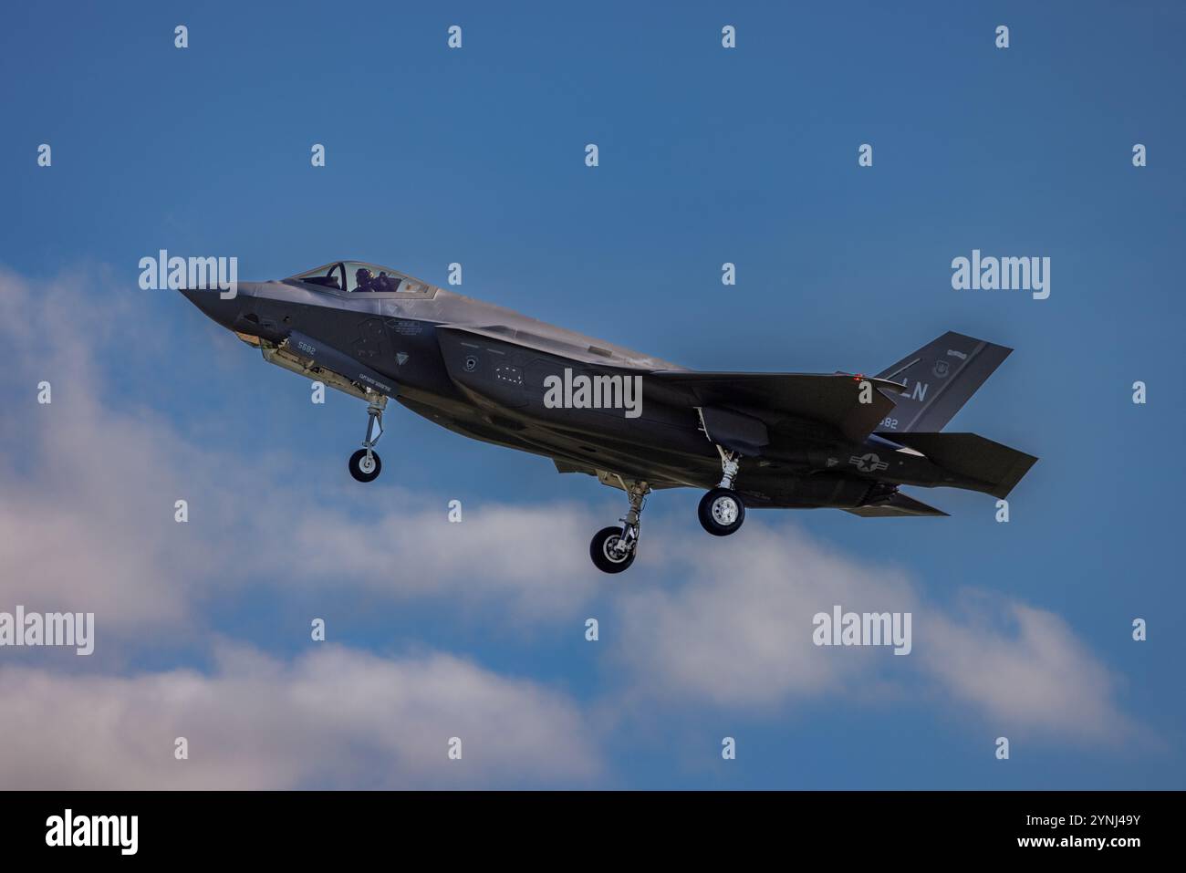 An F-35 Lightning II stealth fighter jet captured in mid-flight, showcasing its sleek design and ...