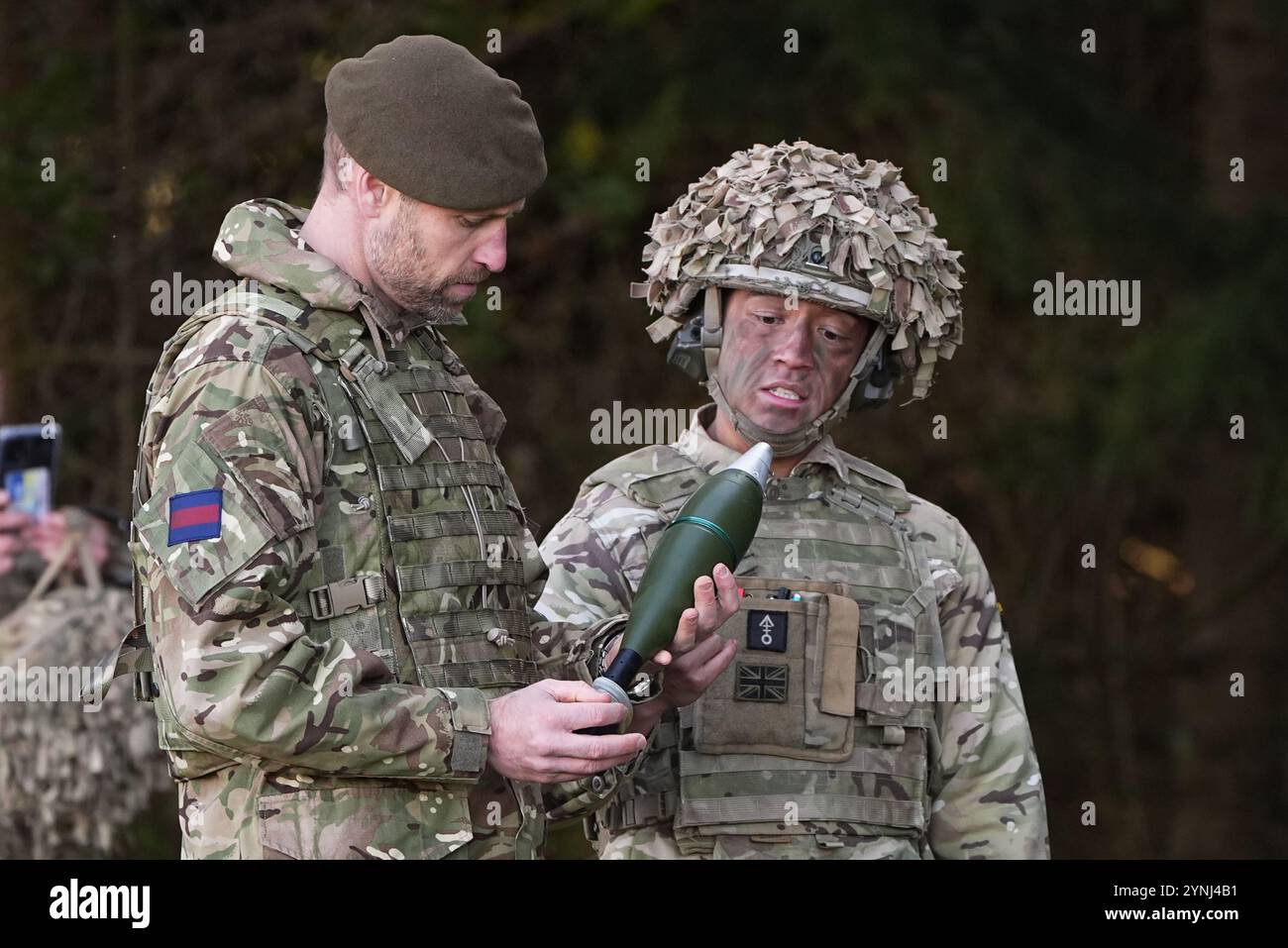 The Prince of Wales, Colonel of the Welsh Guards, (left) holding an 81 mm mortar high explosive ...