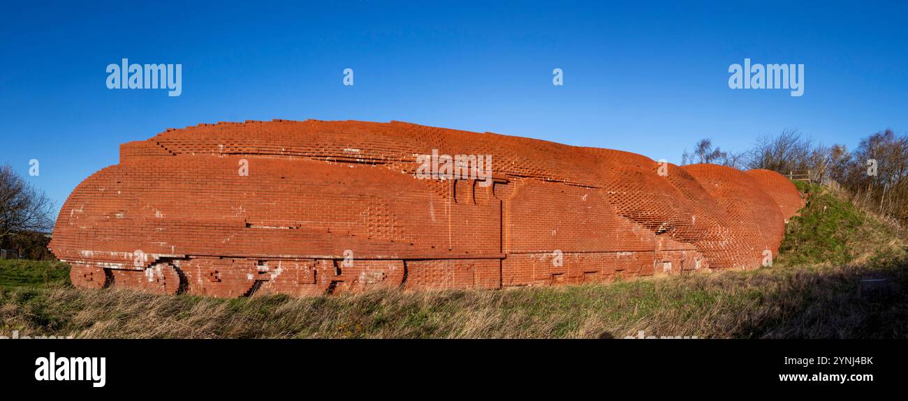 Unique red brick sculpture of a Mallard train in steam in an outdoor ...