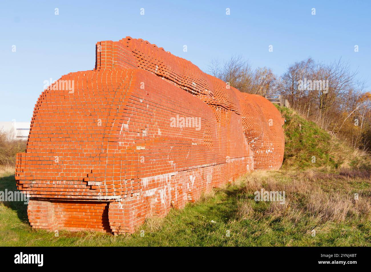 Unique red brick sculpture of a Mallard train in steam in an outdoor ...