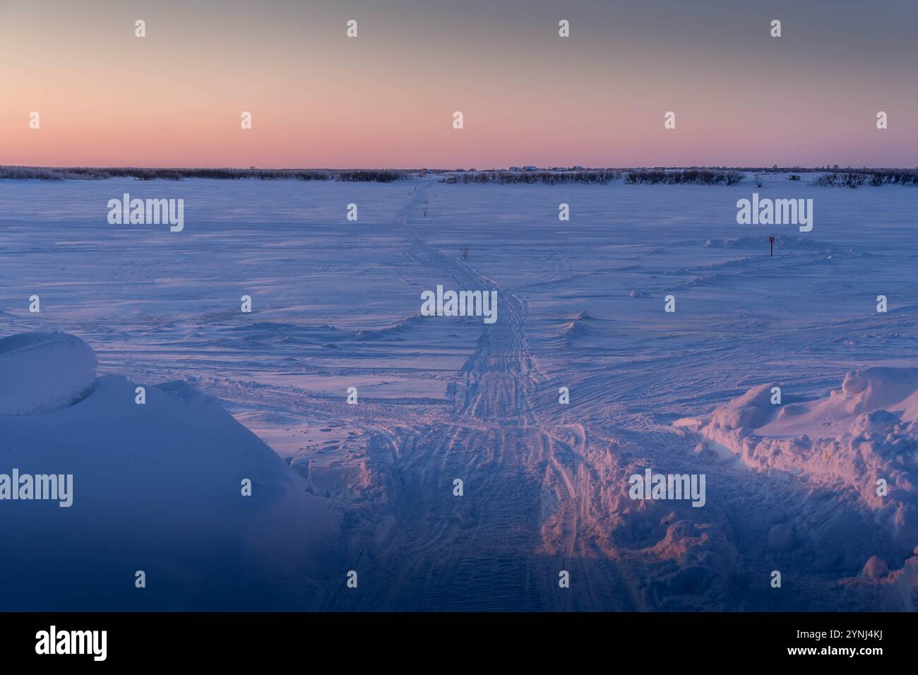 The snowmobile trail on the snow of frozen Pechora river in Russian ...