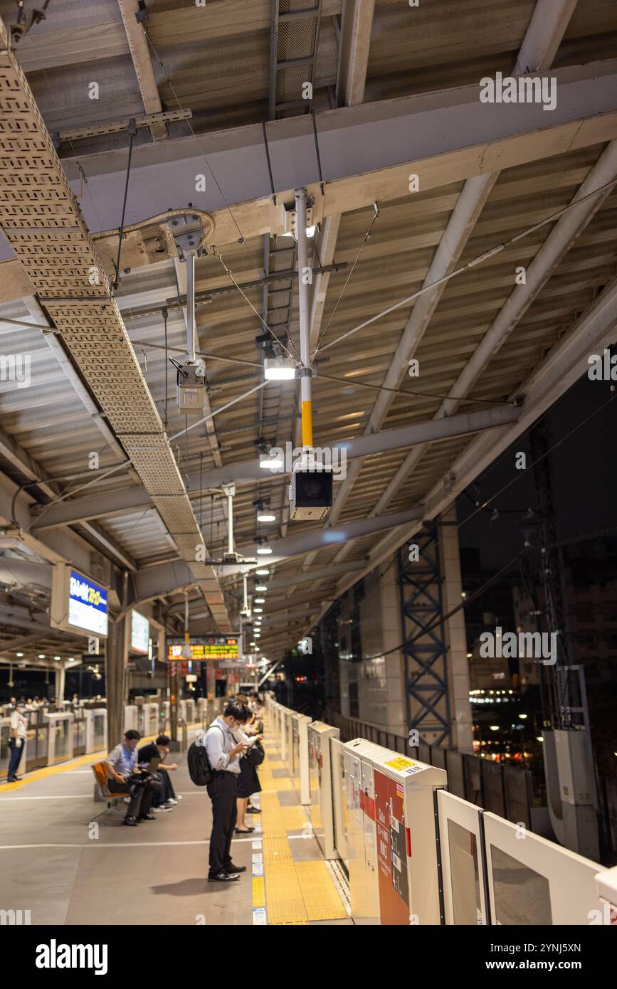 Quiet Tokyo Subway Platform at Night with Waiting Passengers Stock ...