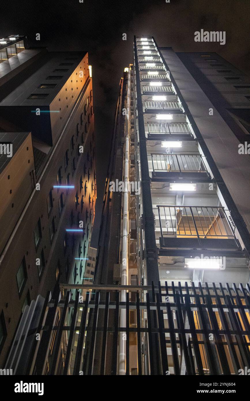 High-Rise Apartment Buildings Illuminated at Night with Staircase ...