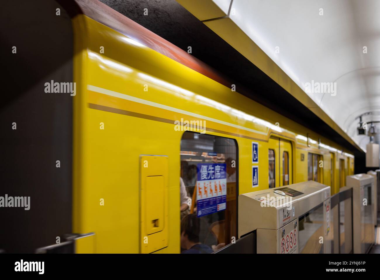 Yellow Subway Train at Underground Station Platform Stock Photo - Alamy
