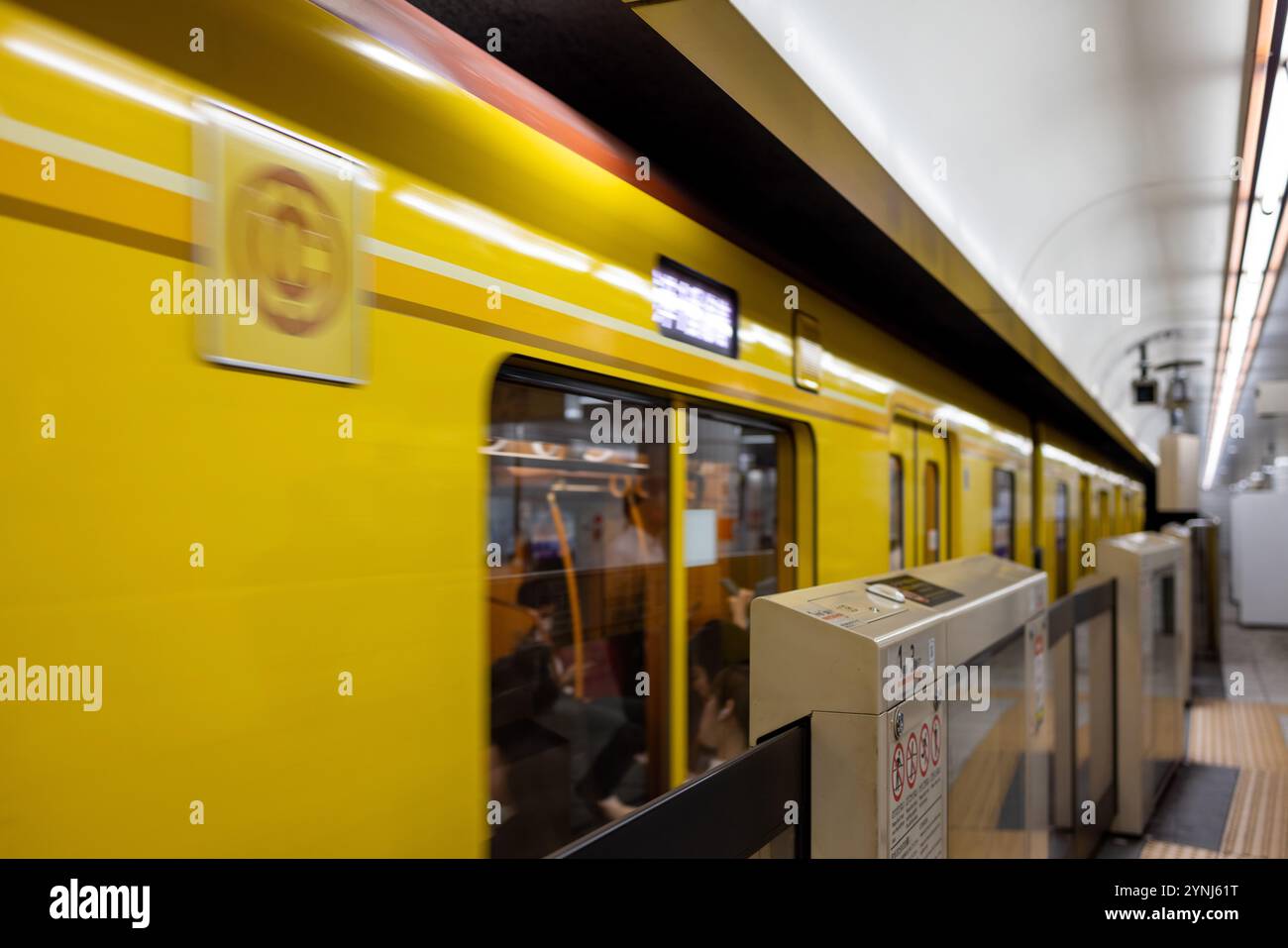 Yellow Metro Train in Motion at Underground Station Stock Photo - Alamy