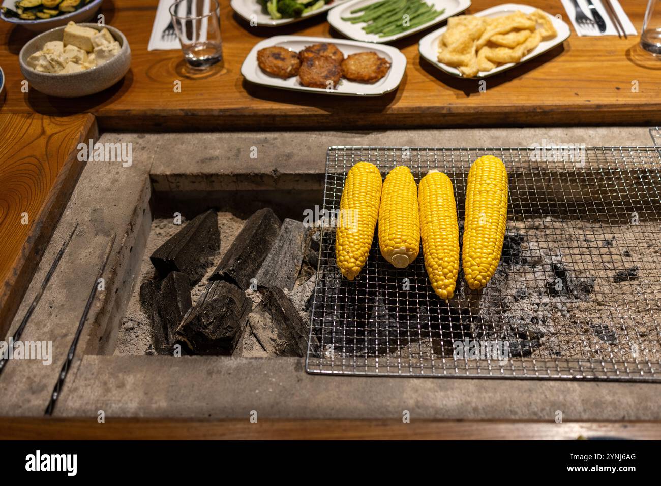 Rustic Grilled Corn on the Cob with Assorted Dishes – Traditional ...