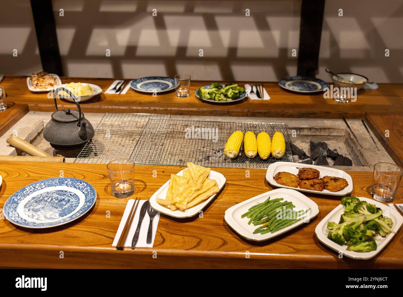 Traditional Japanese Irori Dining with Grilled Corn and Assorted Side ...
