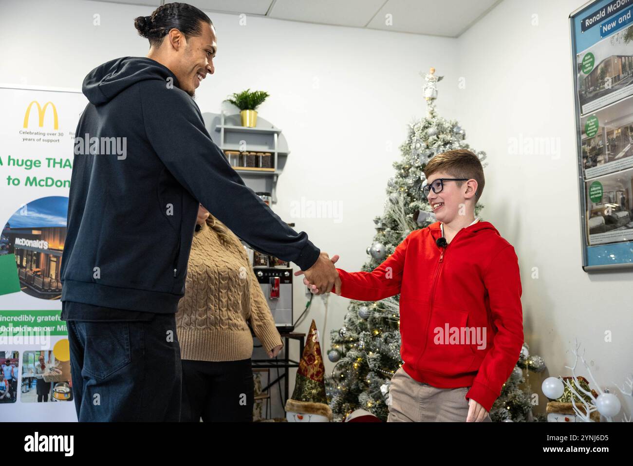 EDITORIAL USE ONLY Liverpool Football Captain Virgil Van Dijk meets ten-year-old Oliver Johnson ...