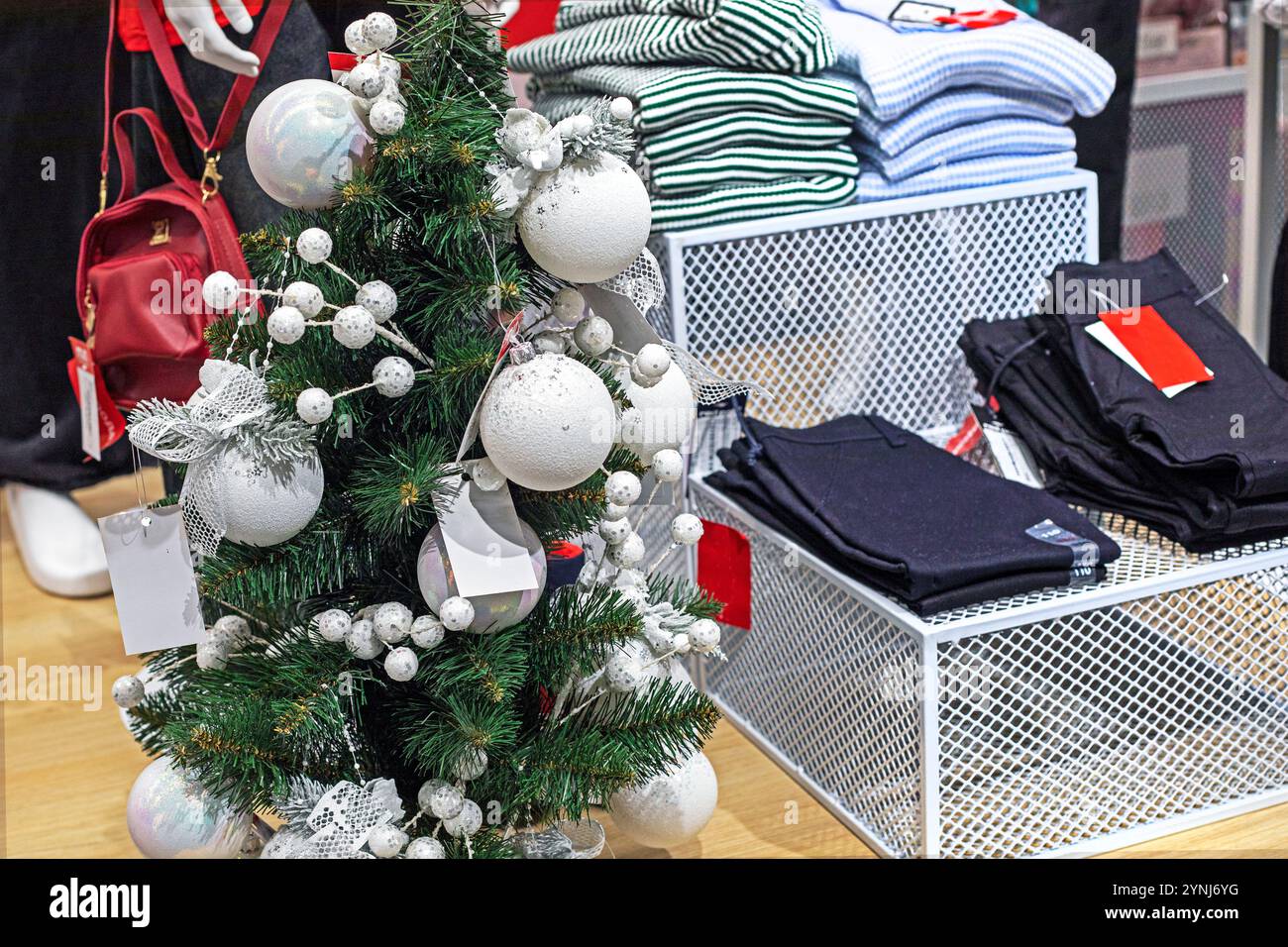 Christmas tree on the shelf near things in the supermarket. Christmas ...